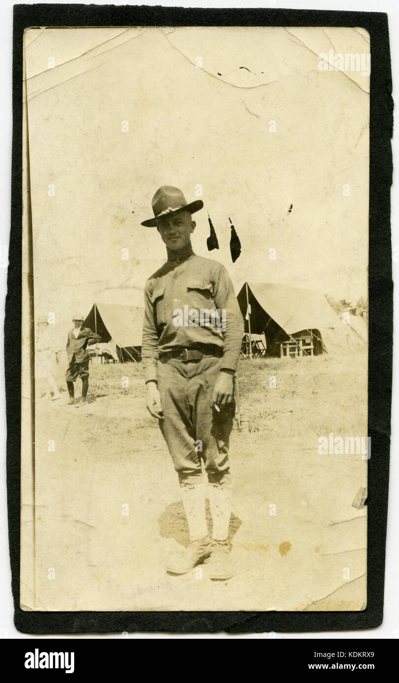 A photograph of a man in military uniform posing in a grass field ...