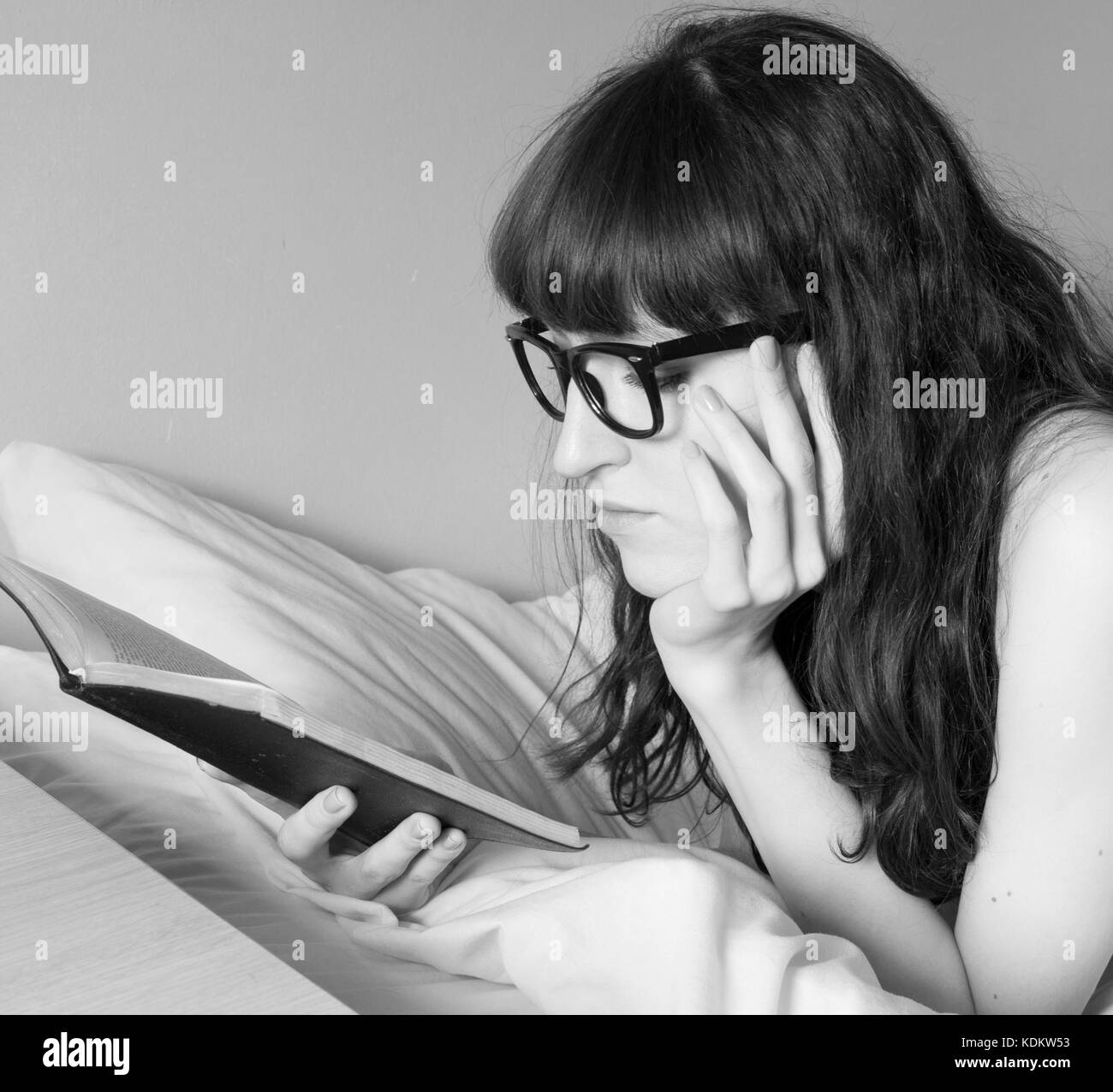 30th June 2015 - Tall girl student reading in her room Stock Photo - Alamy