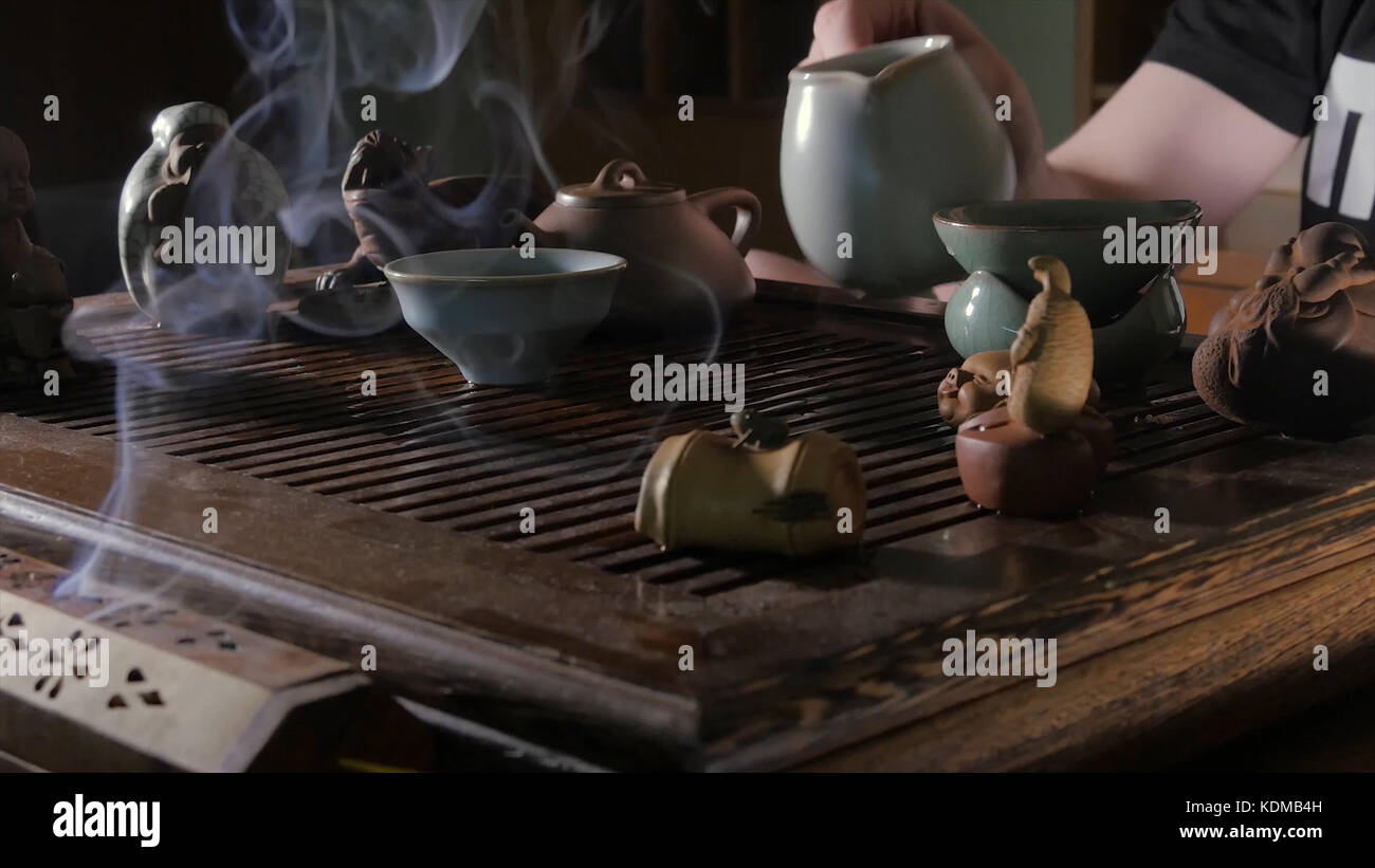 Traditional Chinese Tea Ceremony and pour the tea in a glass of the ...