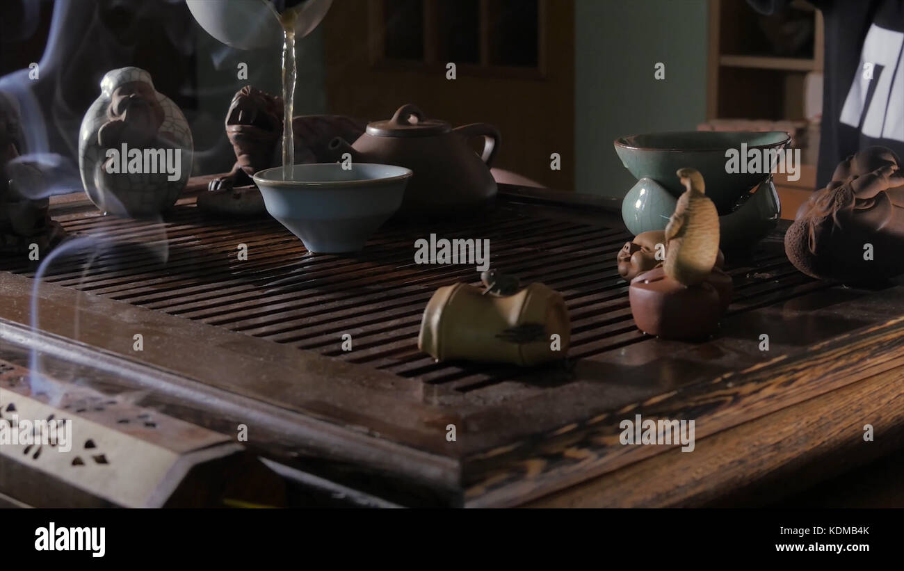 Traditional Chinese Tea Ceremony and pour the tea in a glass of the ...