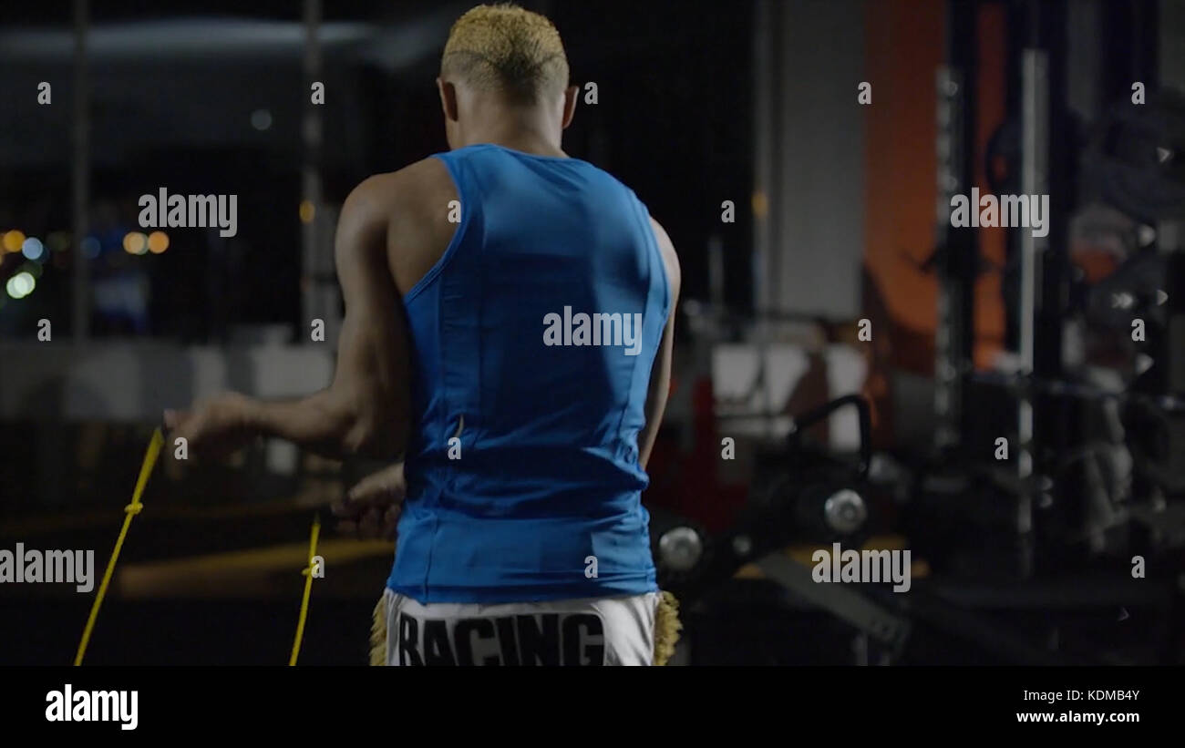 Muscular man skipping rope. Portrait of muscular young man exercising ...