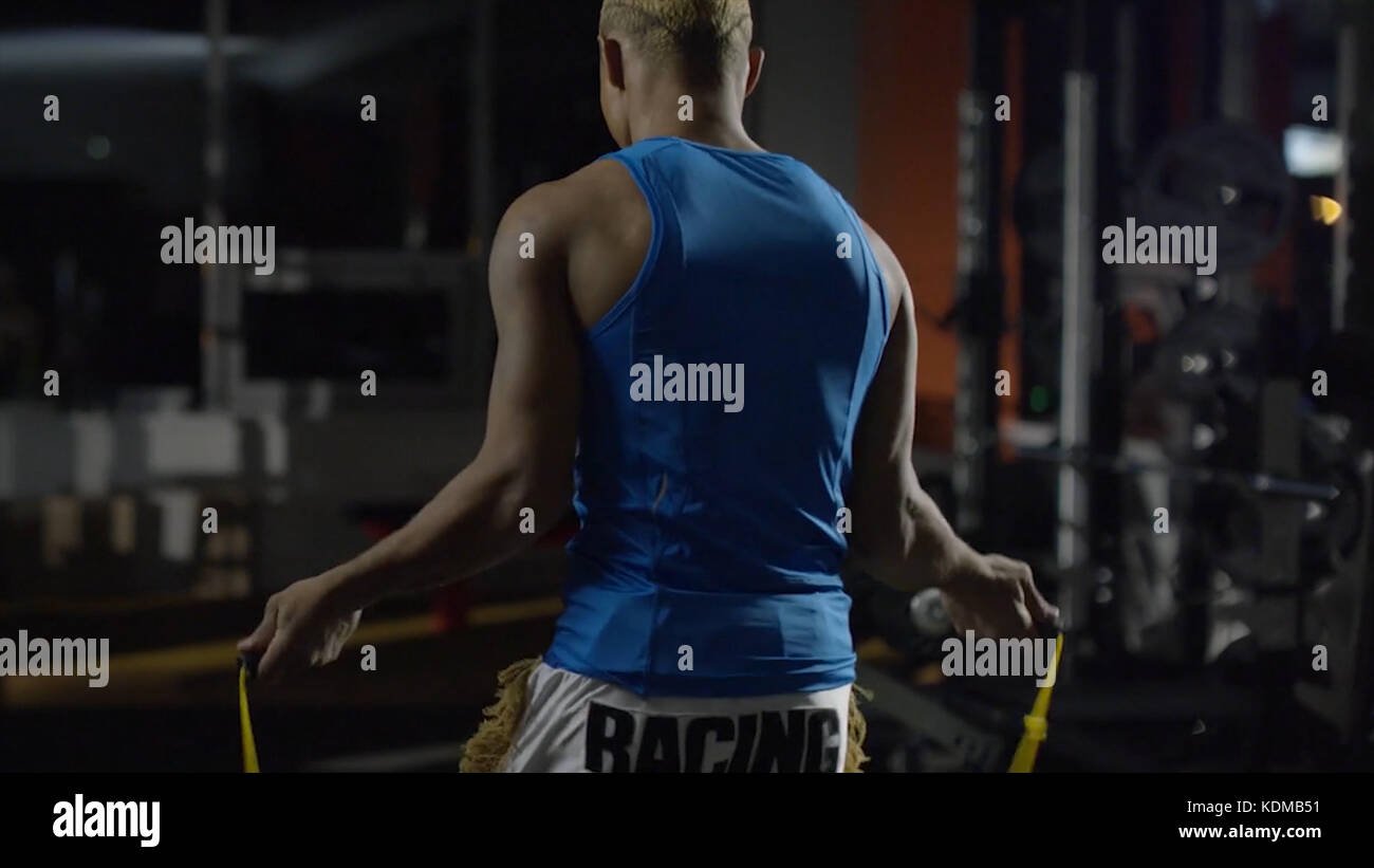 Muscular man skipping rope. Portrait of muscular young man exercising ...