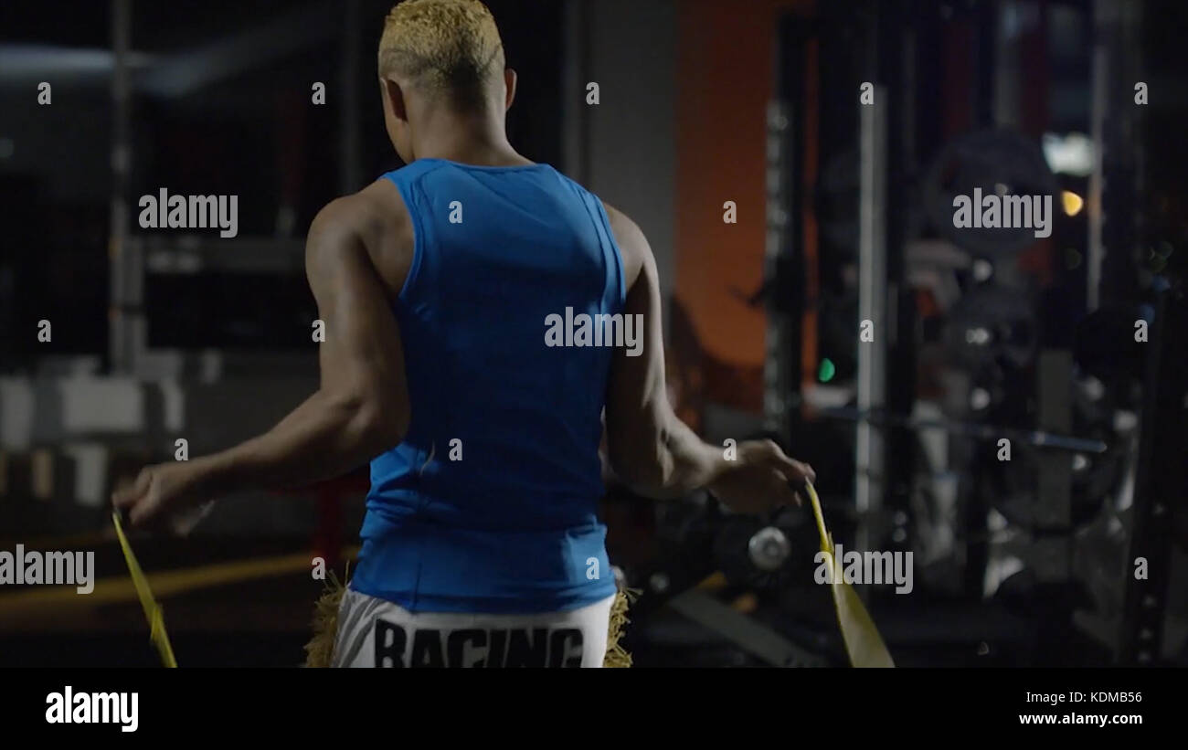 Muscular man skipping rope. Portrait of muscular young man exercising ...