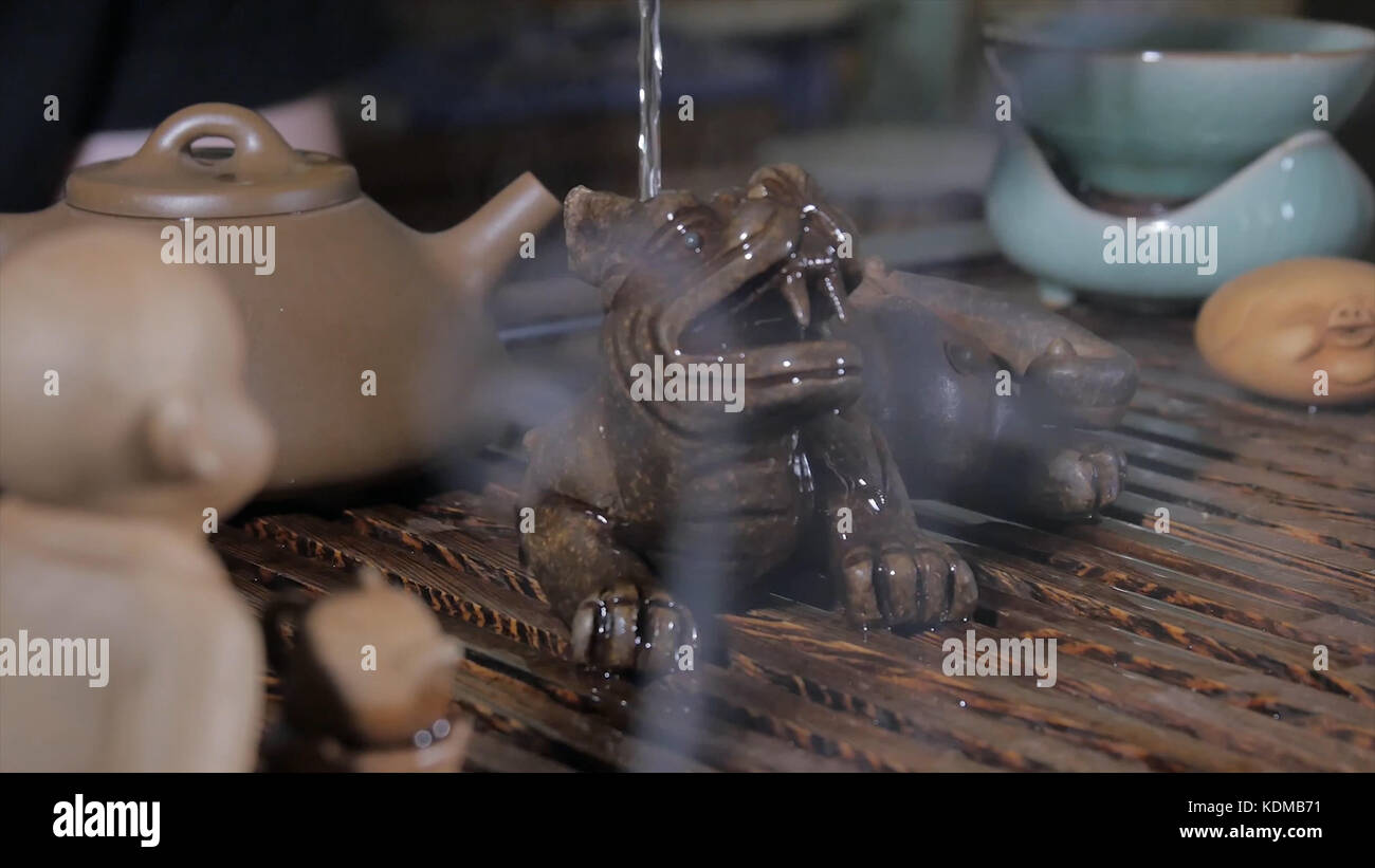 Traditional Chinese Tea Ceremony and pour the tea in a glass of the ...