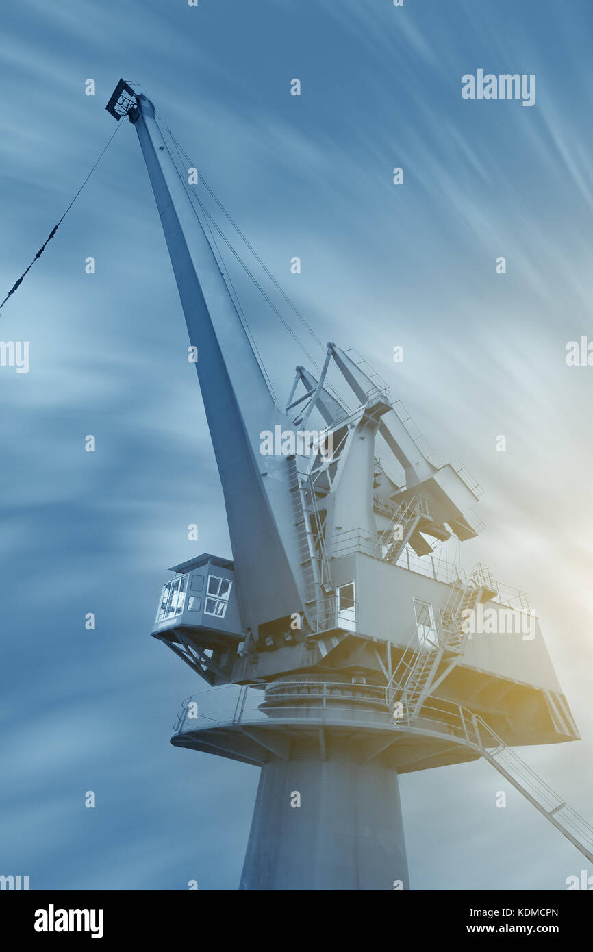 Industrial Crane operating and lifting an electric generator against ...