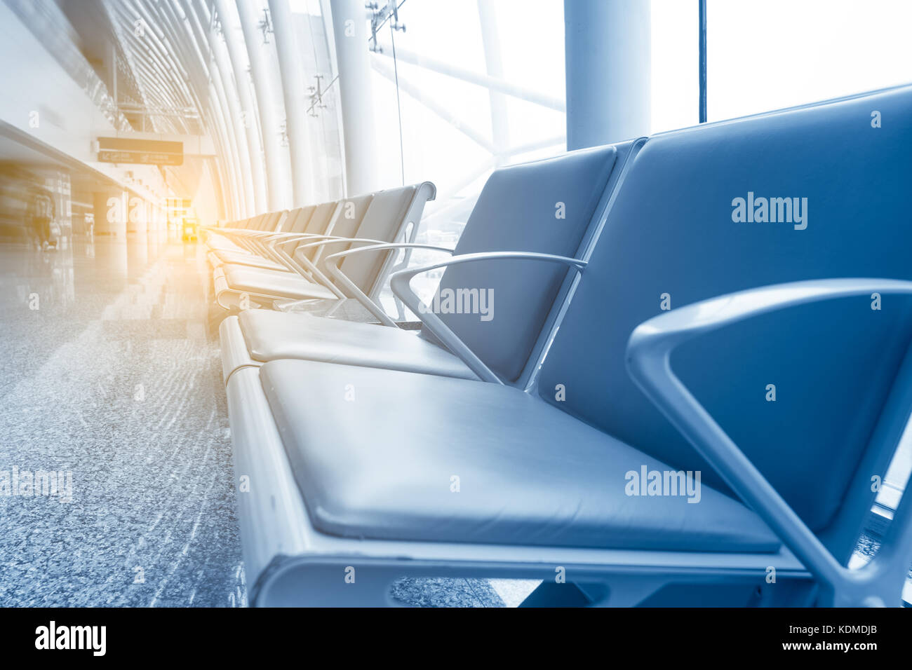 Row of leather chairs in international airport terminal at window ...