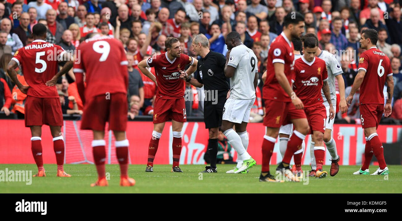Referee Martin Atkinson speaks to Liverpool's Jordan Henderson and ...