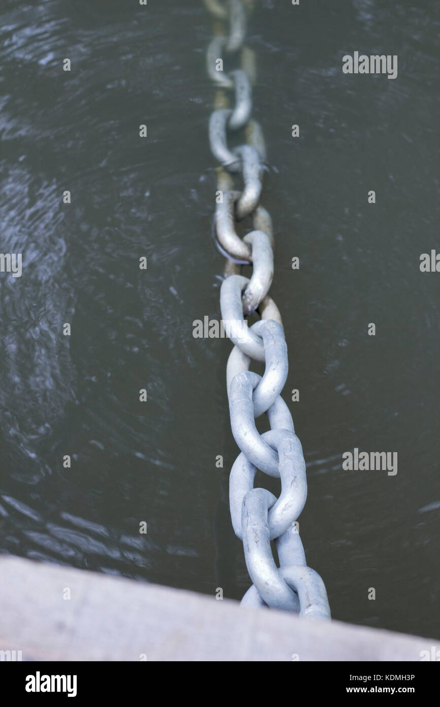 Chain coming out of water Stock Photo - Alamy