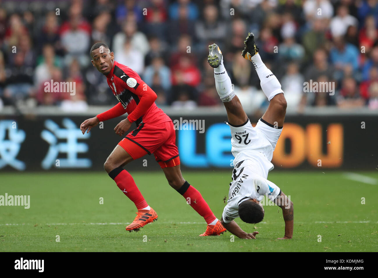 Swansea City's Kyle Naughton (left) lands on his head after clashing ...