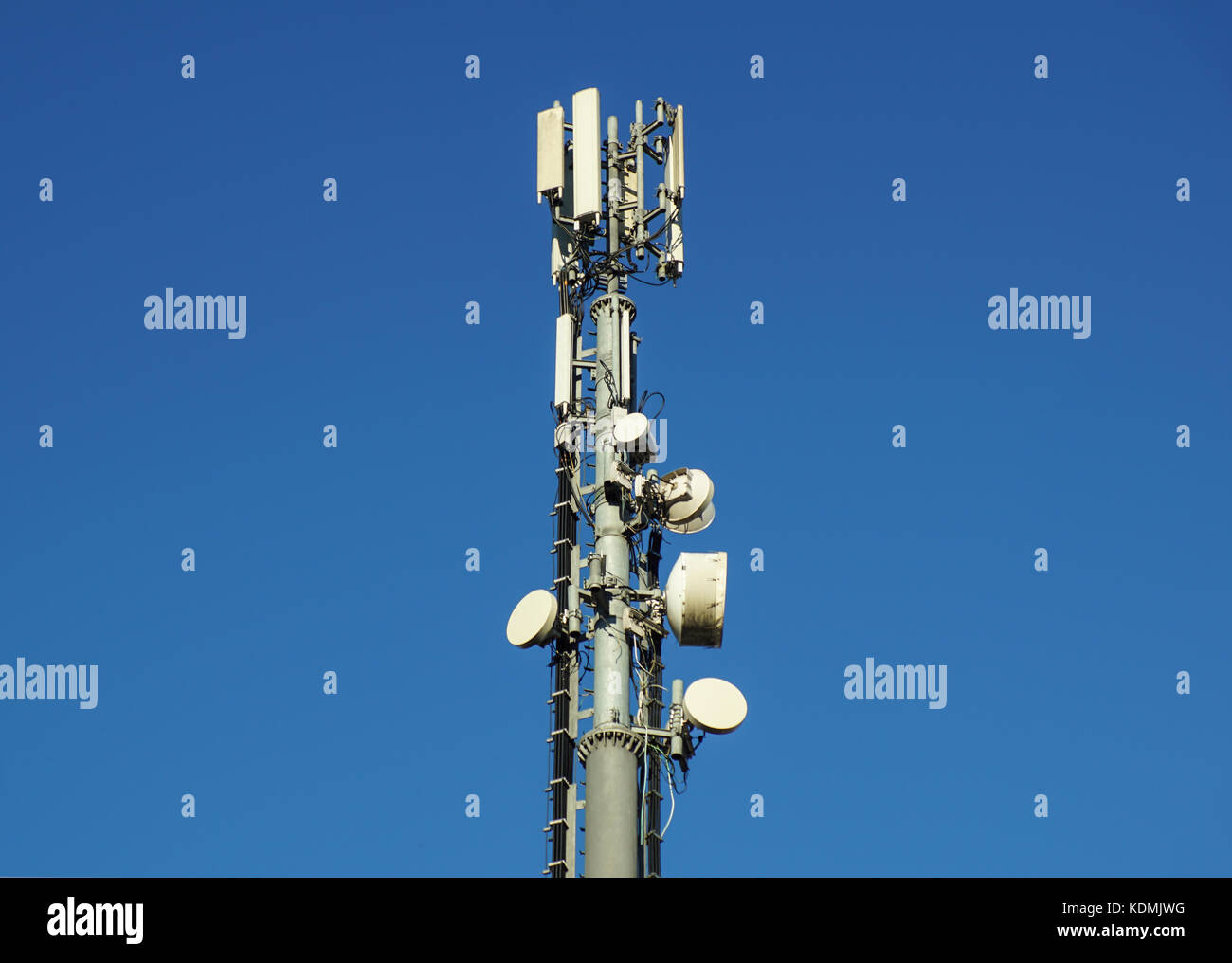 Top part of cell phone communication tower with multiple antennas ...