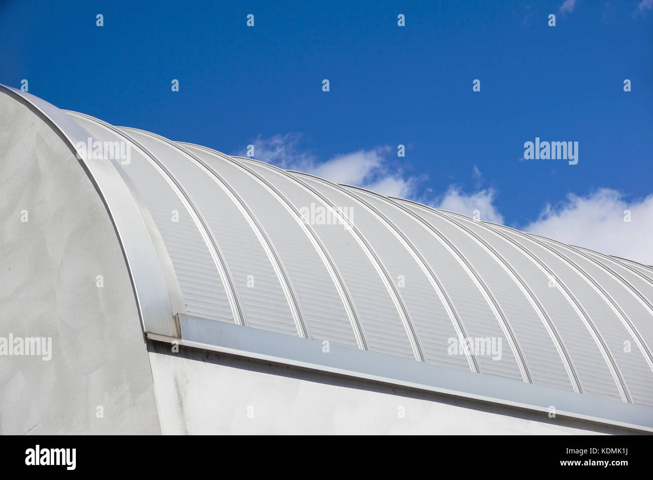 Modern construction. Metal ribbed arch-span roof covering. Looking up ...