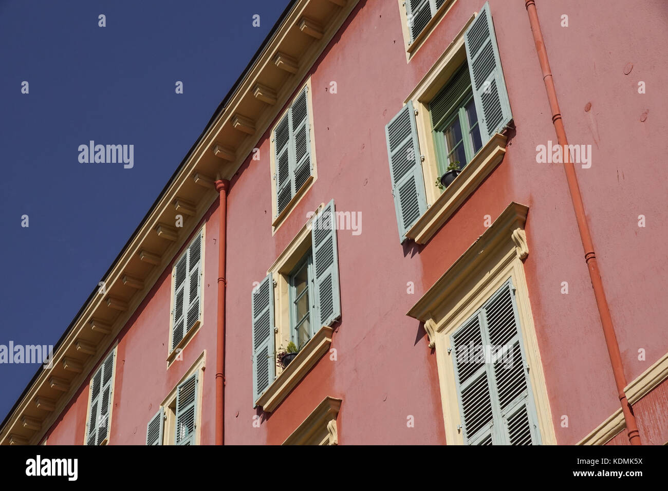 Pink building with blue sky for background Stock Photo - Alamy