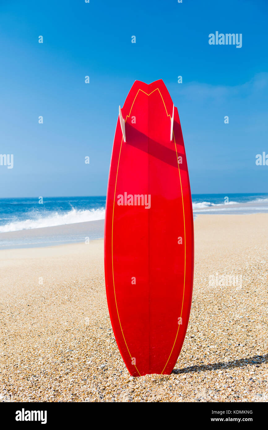 Beach landscape with a red surfboard on the sand Stock Photo - Alamy