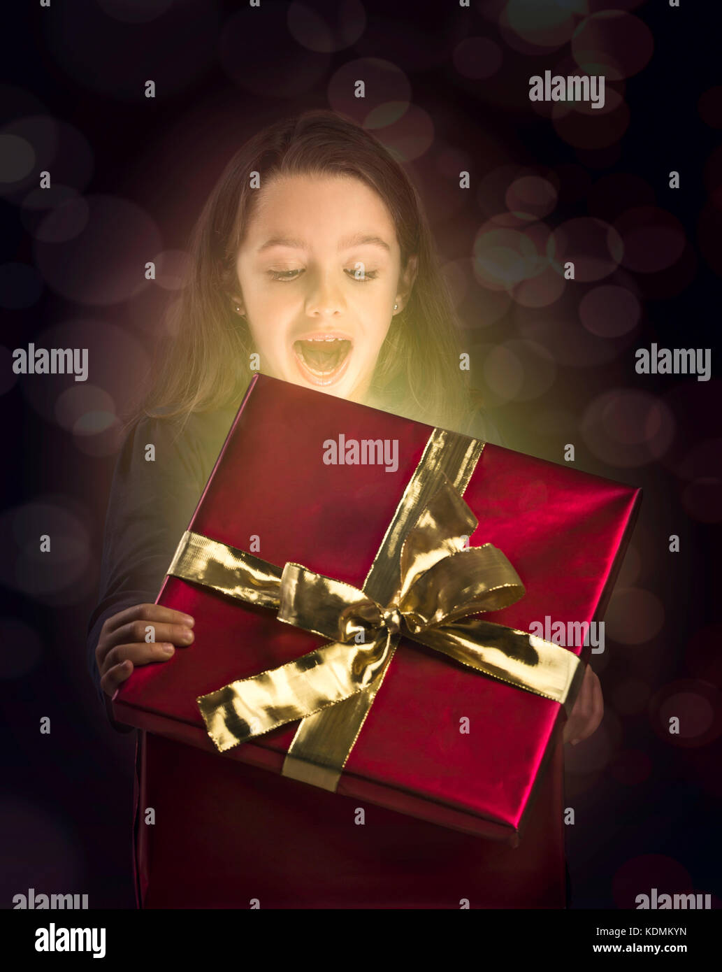 Little girl opening a magic box with light coming out Stock Photo - Alamy