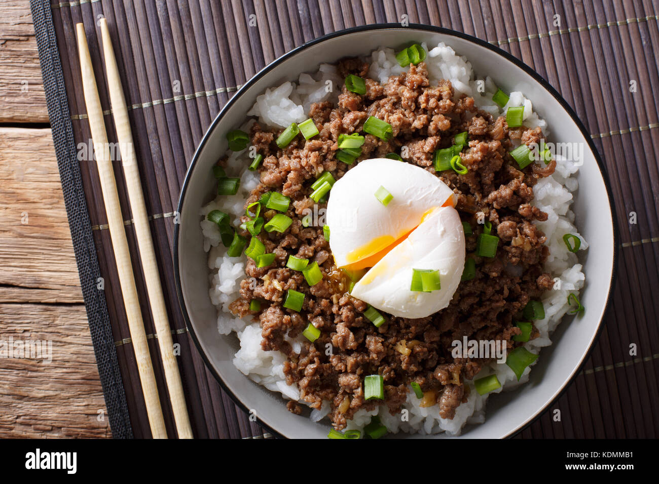 Japanese dish: spicy meat Soboro with egg poached and rice close-up in ...