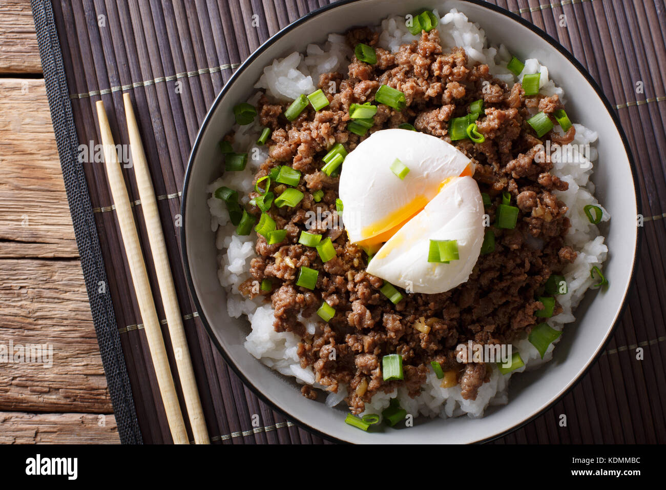 Beef Soboro with egg poached, rice and green onion close-up in a bowl ...