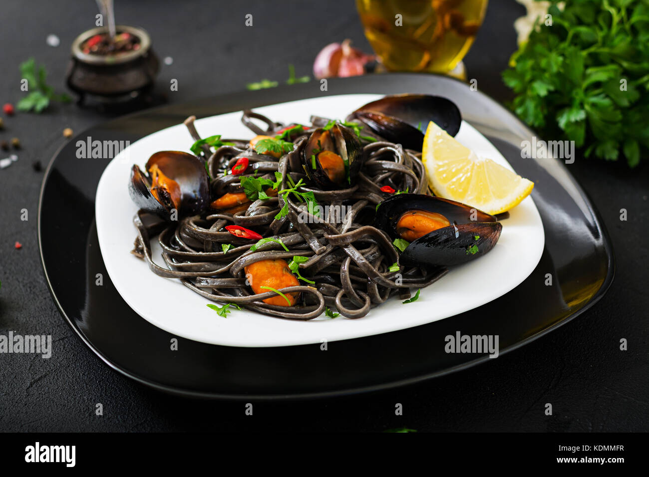 Black spaghetti. Black seafood pasta with mussels over black background ...