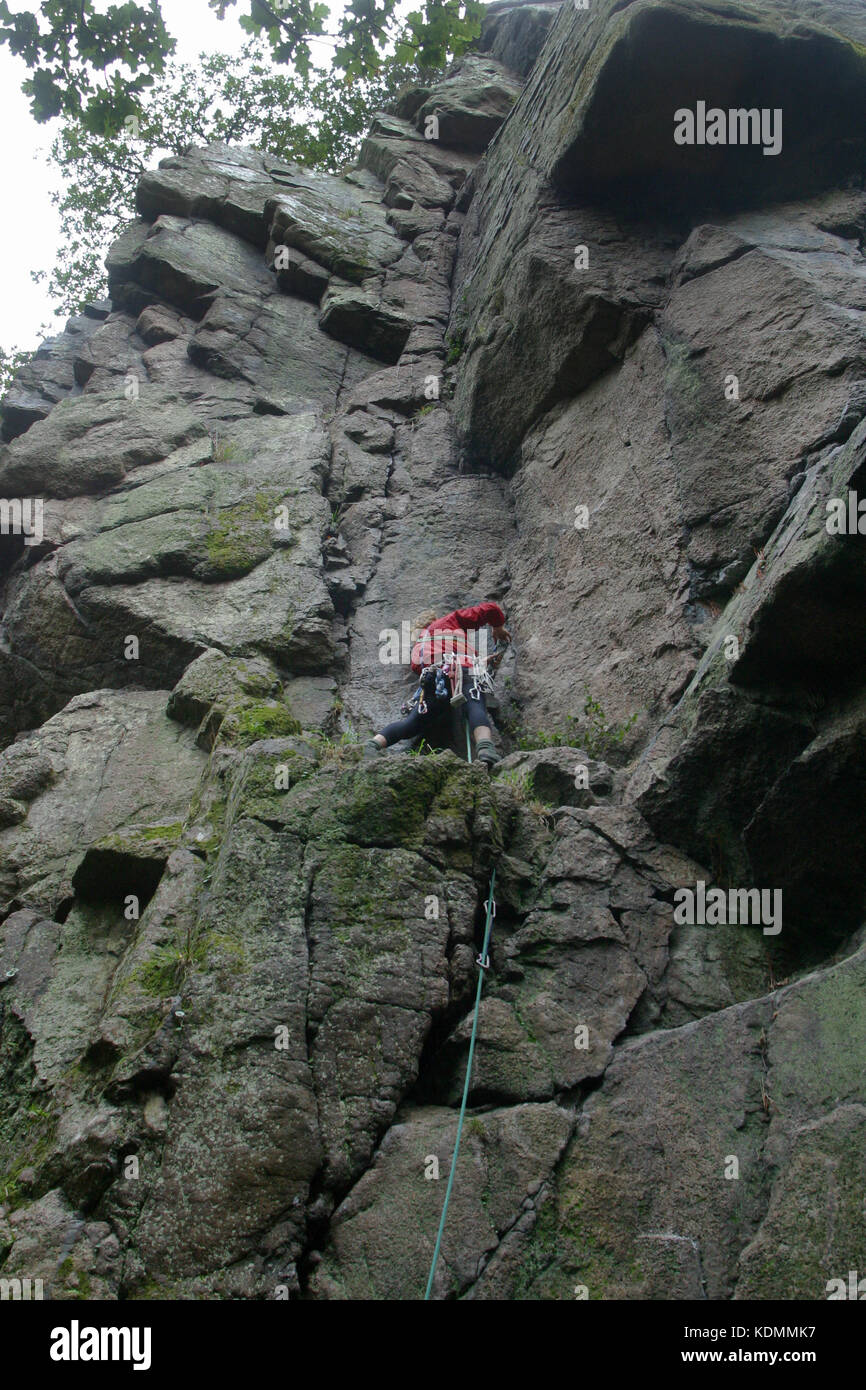 A rock climber makes an ascent of the Dewerstone, in Dartmoor Stock ...