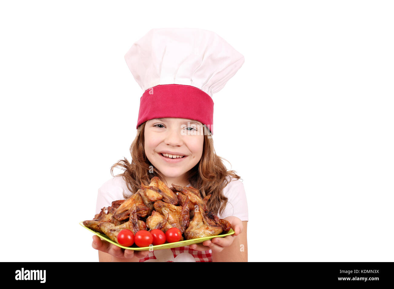 happy little girl cook with roasted chicken wings on plate Stock Photo ...
