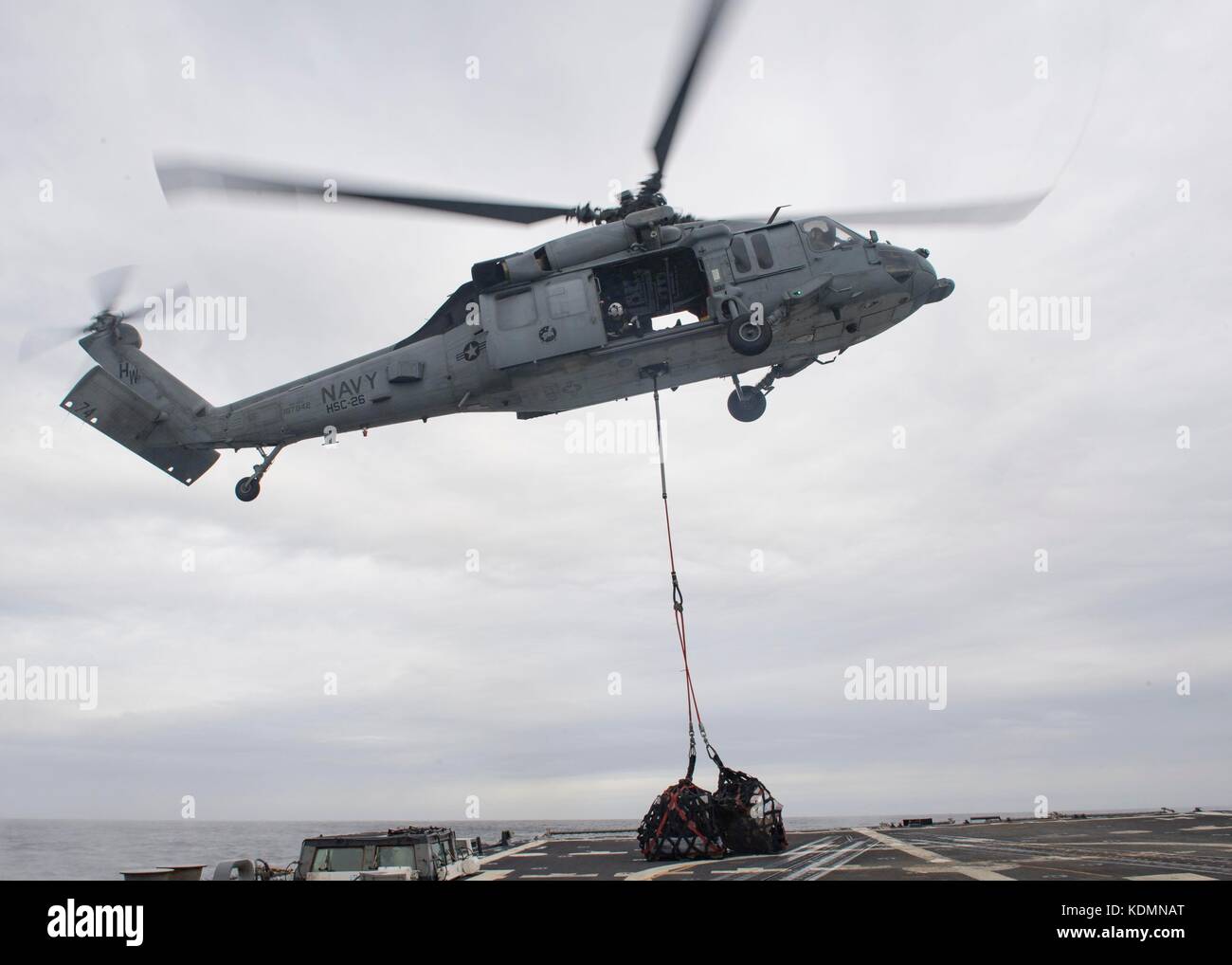 An MH-60S Sea Hawk helicopter delivers supplies to a ship Stock Photo ...