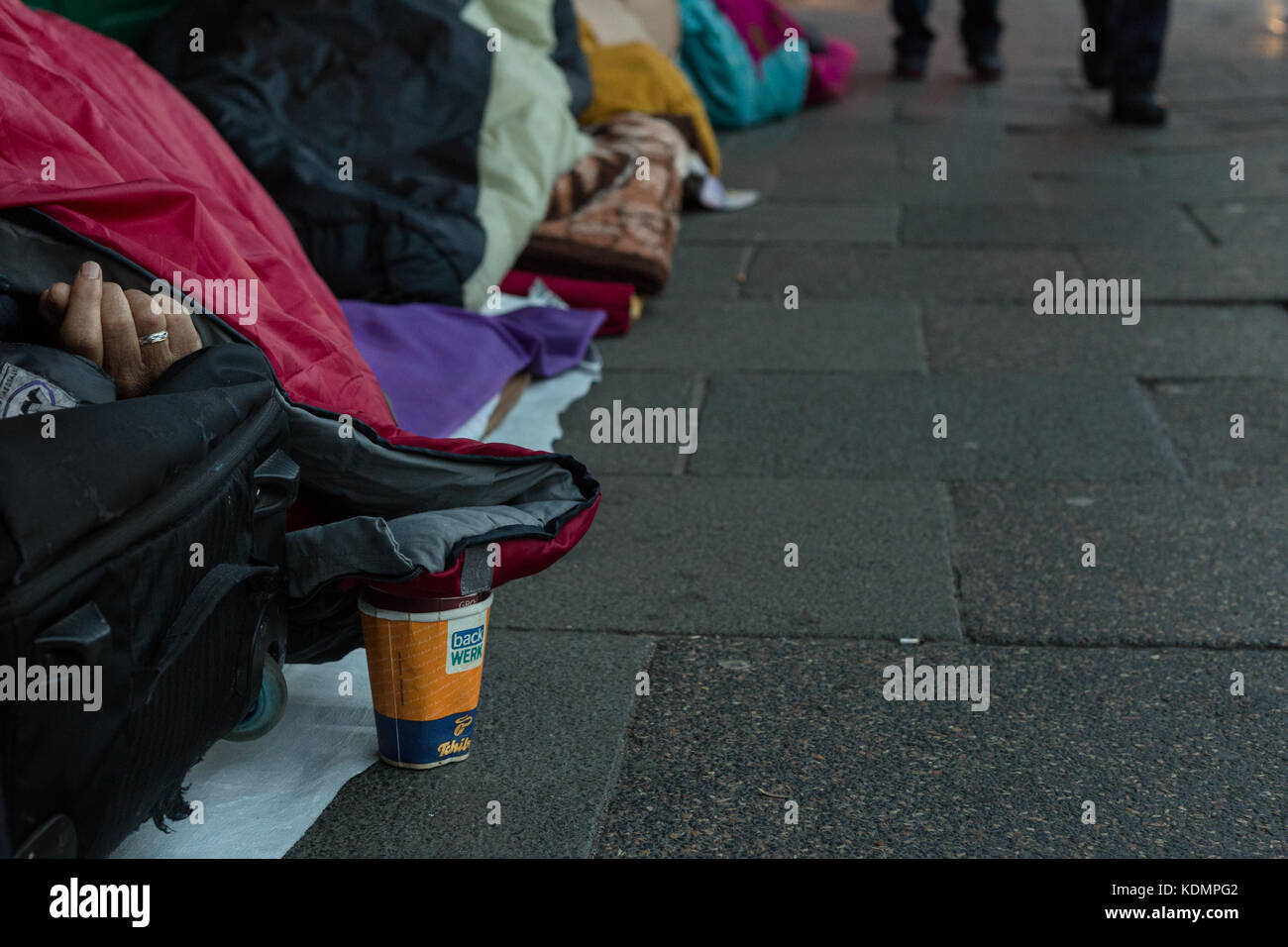 Poor refugee woman without home sleeping on the street of German city ...
