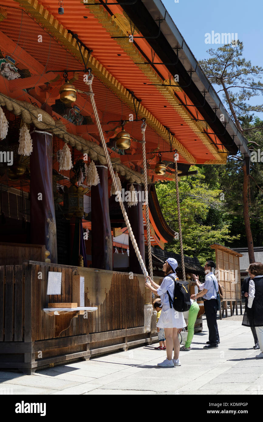 Kyoto, Japan - May 19, 2017: People ringing the bell and praying in ...