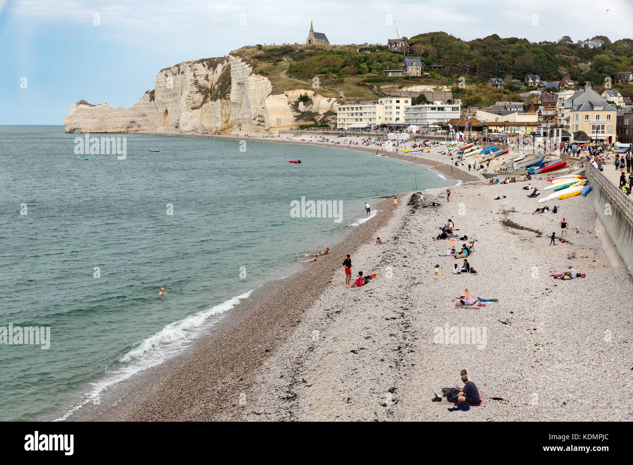 Seaside visitors and fishing boats at beach Etretat, Normandie, France ...