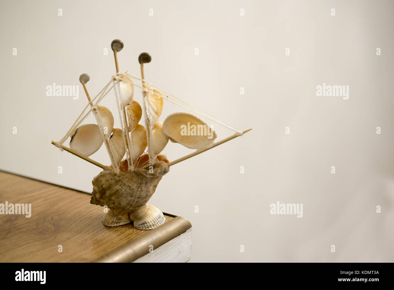 small ship model made of shells on the emerald background of the next ...