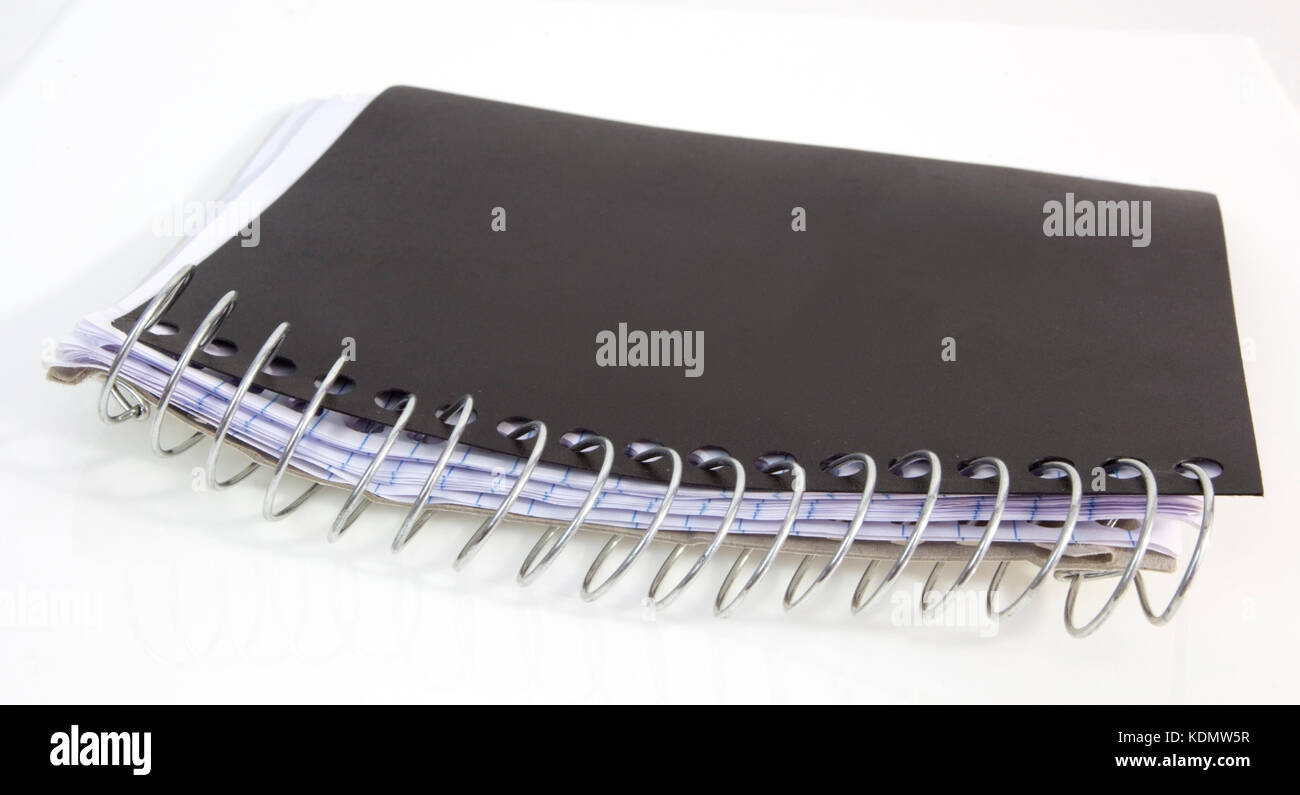 Old, used, bent black spiral notebook. Closed Stock Photo - Alamy