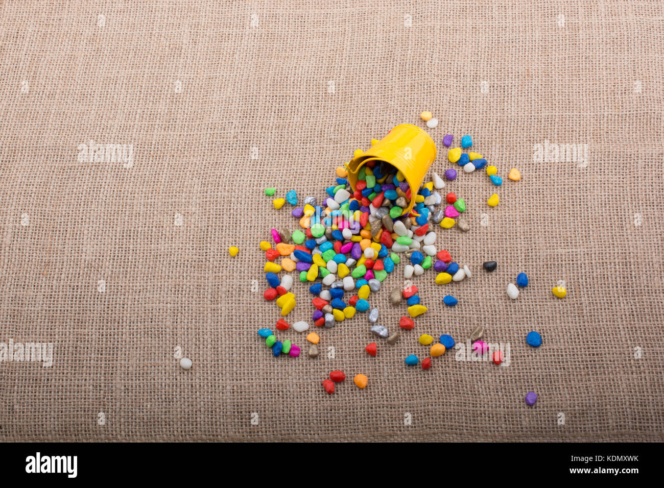 Bucket of colorful pebbles spill on background Stock Photo - Alamy