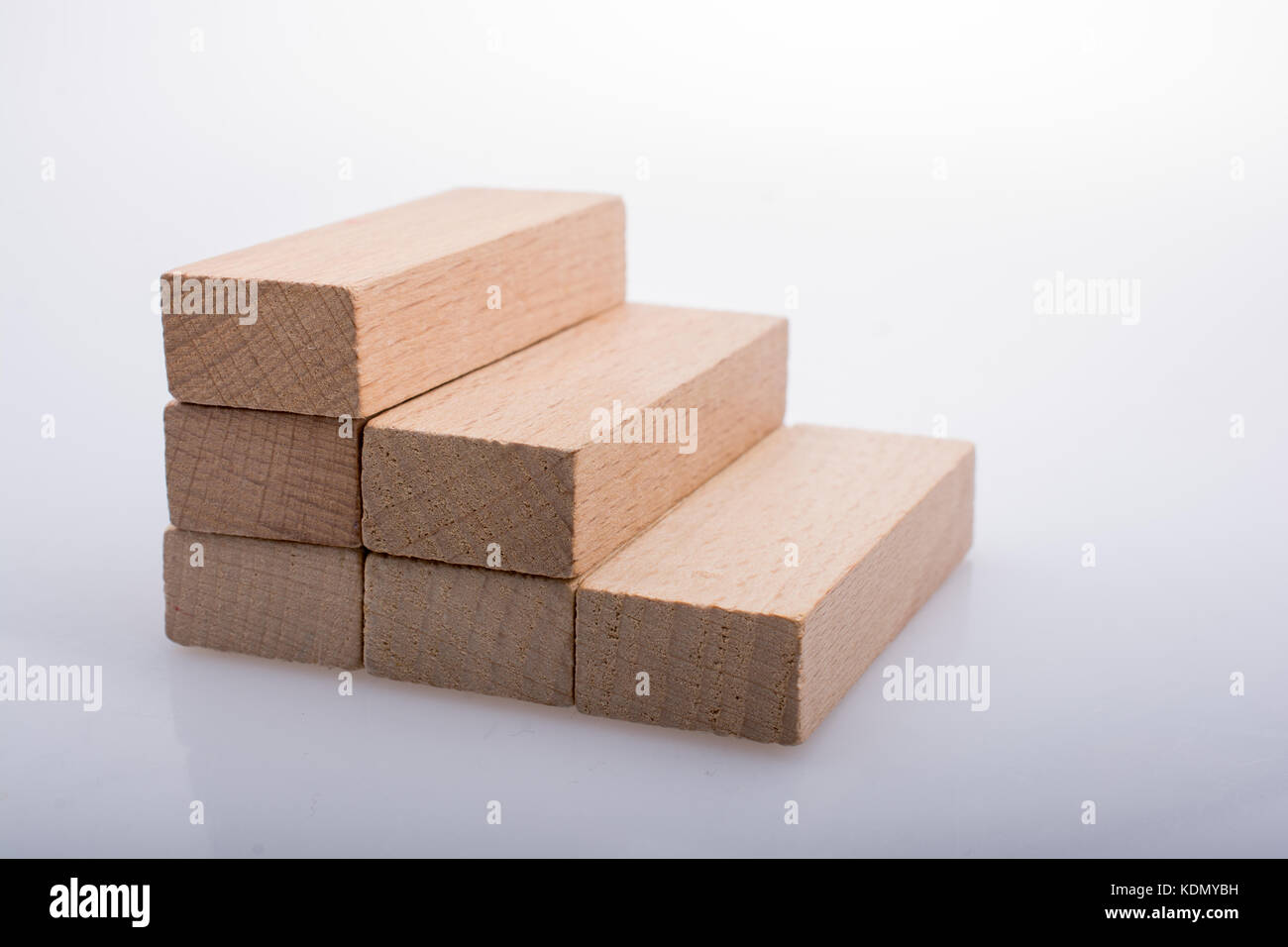 Wooden Domino Blocks in a line on a white background Stock Photo - Alamy