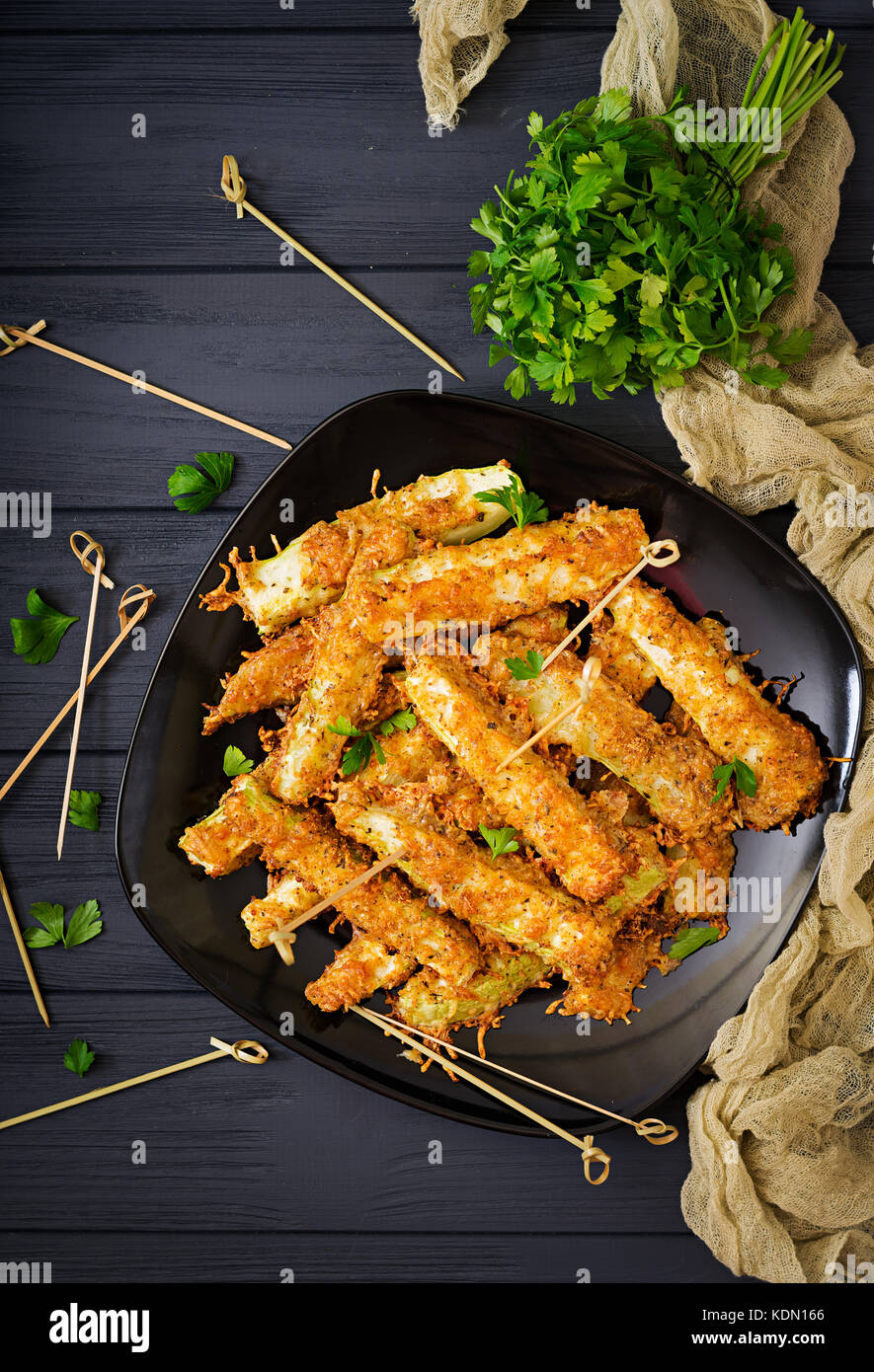 Zucchini slices baked under cheese breading Stock Photo - Alamy