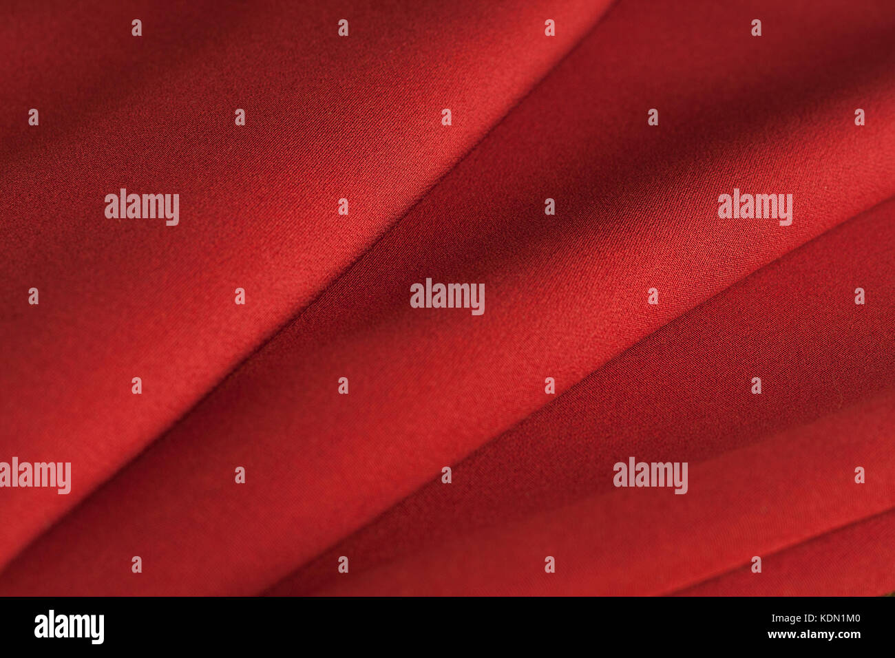 Folds of red knitted fabric close-up Stock Photo - Alamy