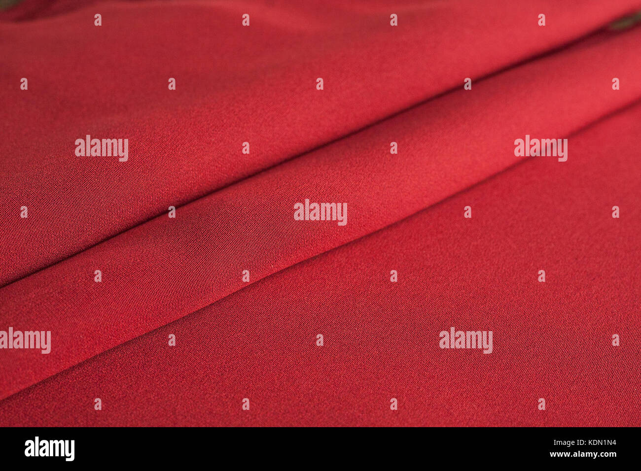 Folds of red knitted fabric close-up Stock Photo - Alamy