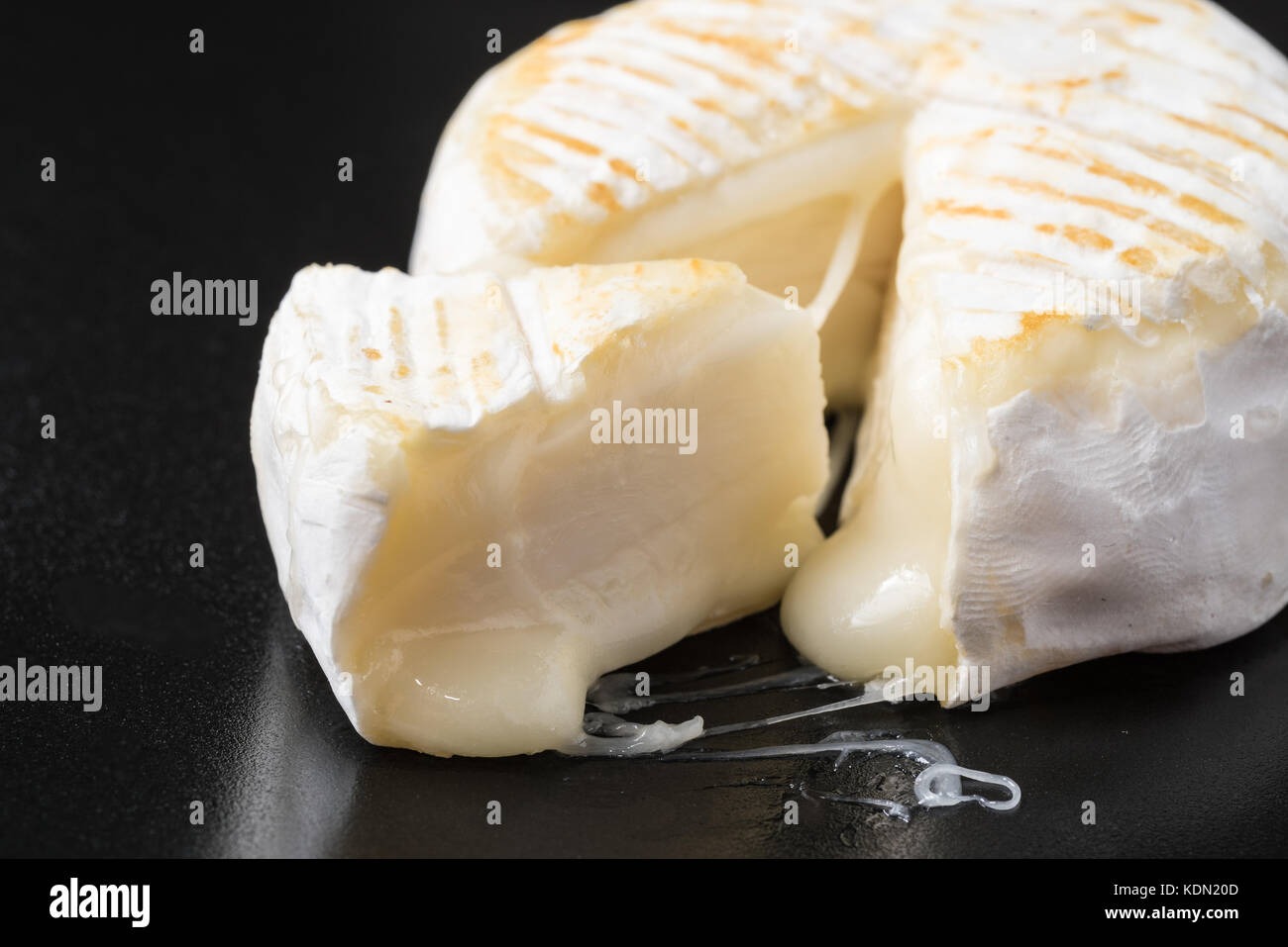 small cow cheese melting after hot grill Stock Photo - Alamy