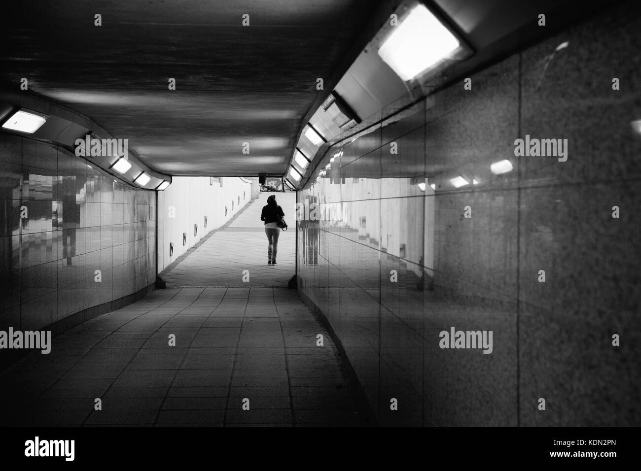 Woman Alone Walking Through Underpass Stock Photo - Alamy