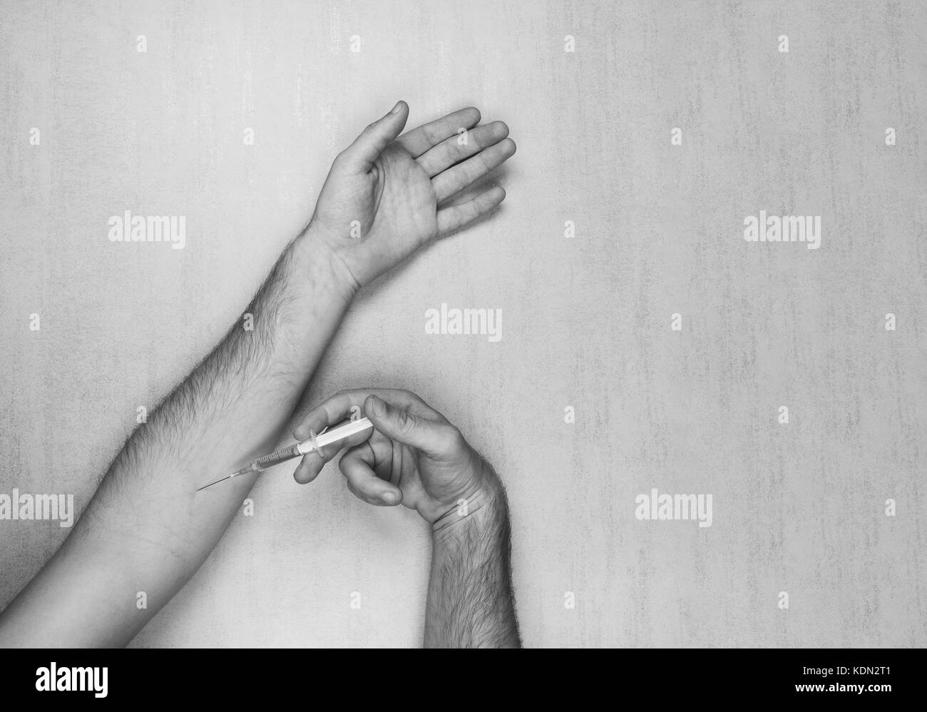 The hands of the man making himself an injection of a disposable ...