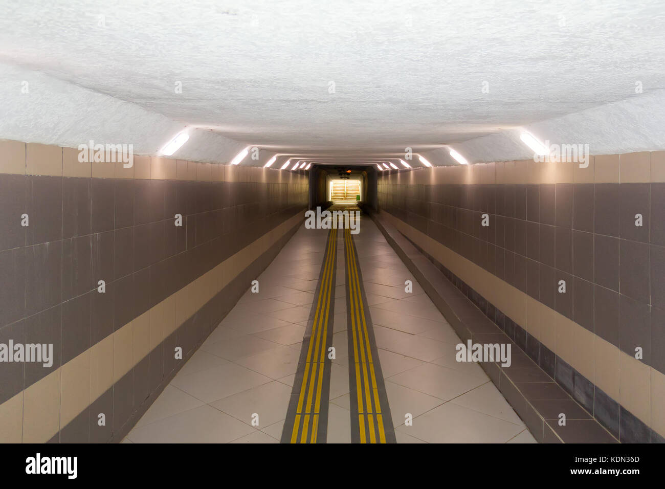 lighted underground passage under the highway, with a low ceiling Stock ...