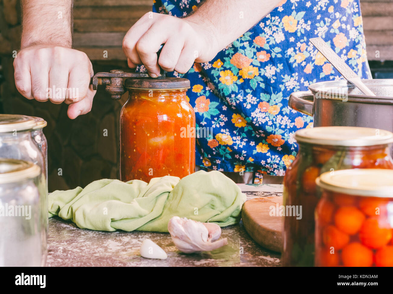 the man takes her in preserving the old rustic kitchen Stock Photo - Alamy