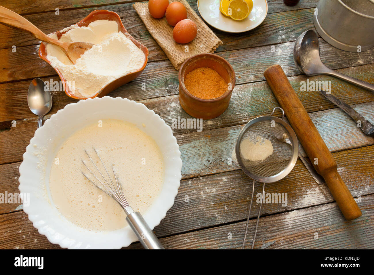 Preparation of the dough in a rustic kitchen. Wheat flour, batter, eggs ...