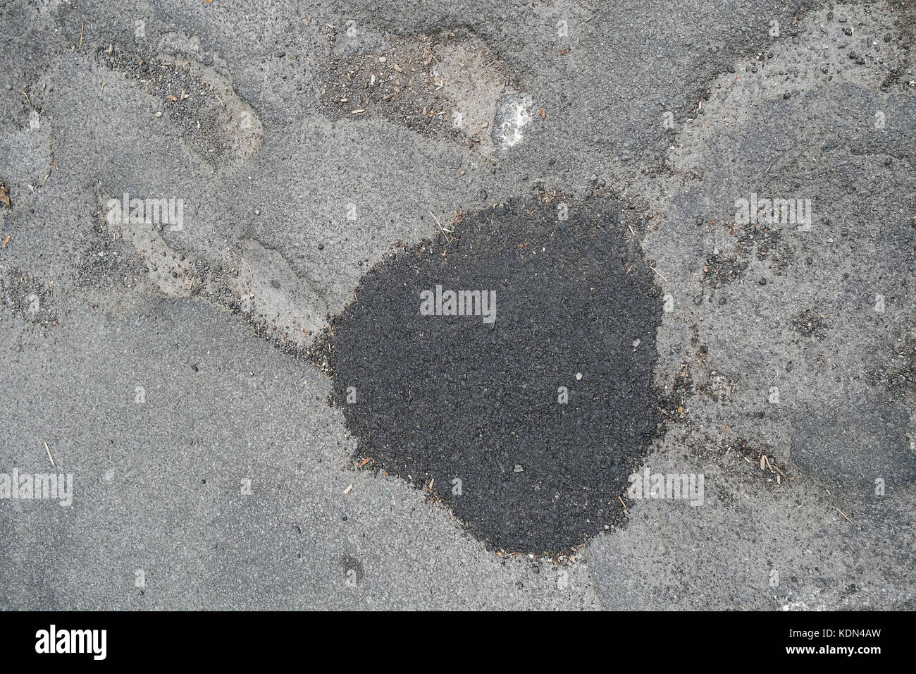 partly repaired pothole in road Stock Photo - Alamy
