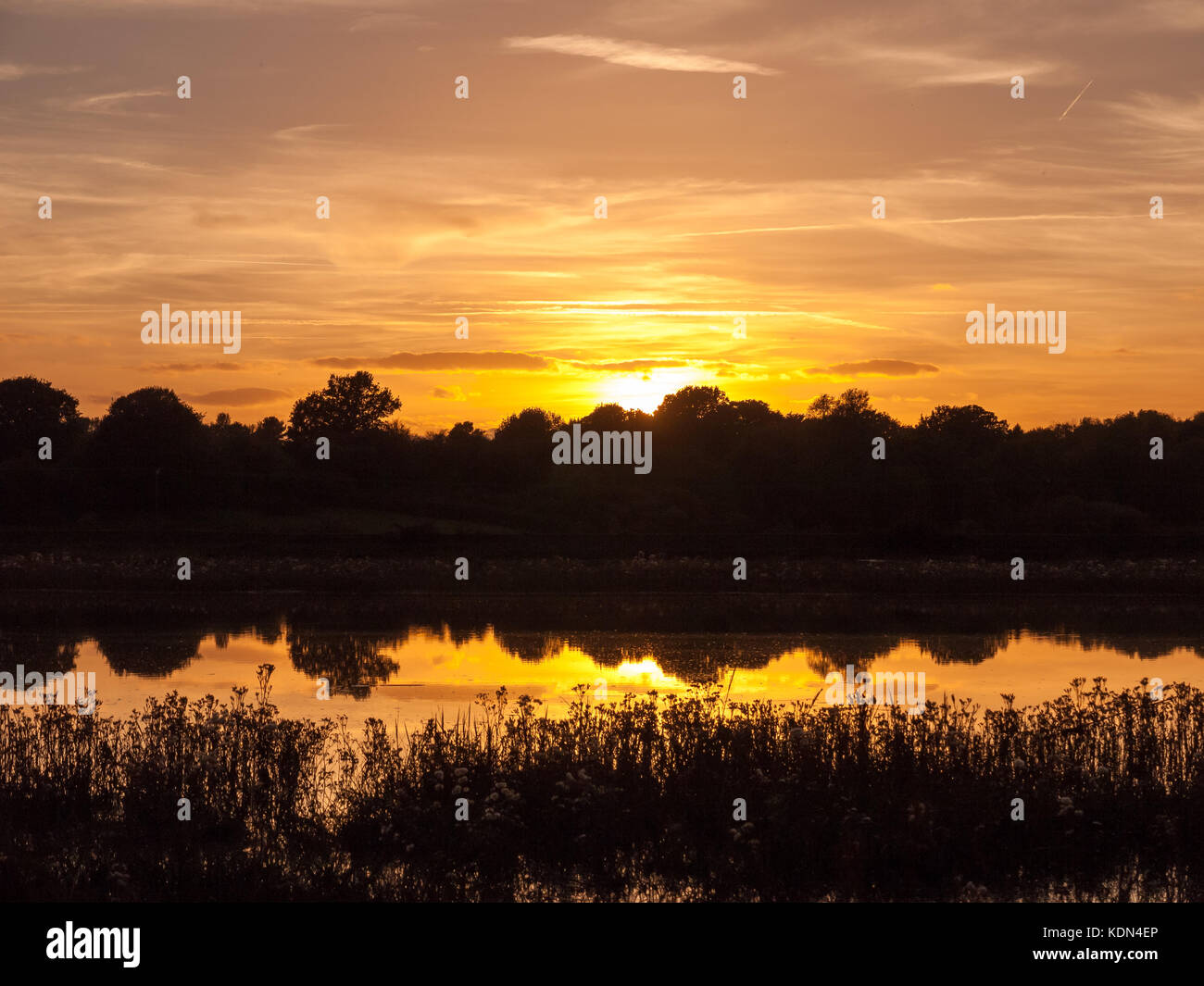 stunning bright autumn harvest sun set scene over lake water reflection ...