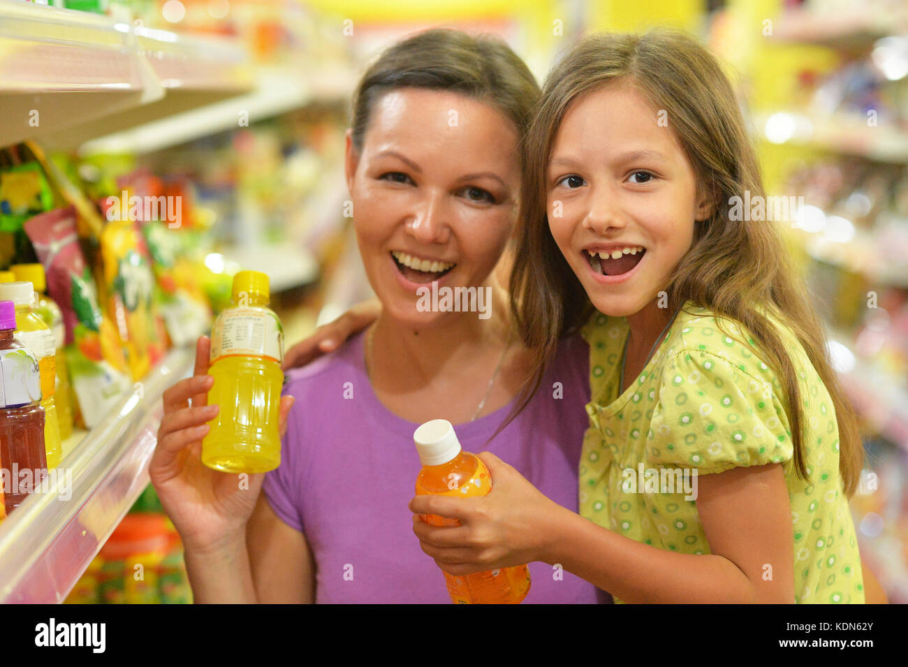 Mother and daughter choosing products in store Stock Photo - Alamy