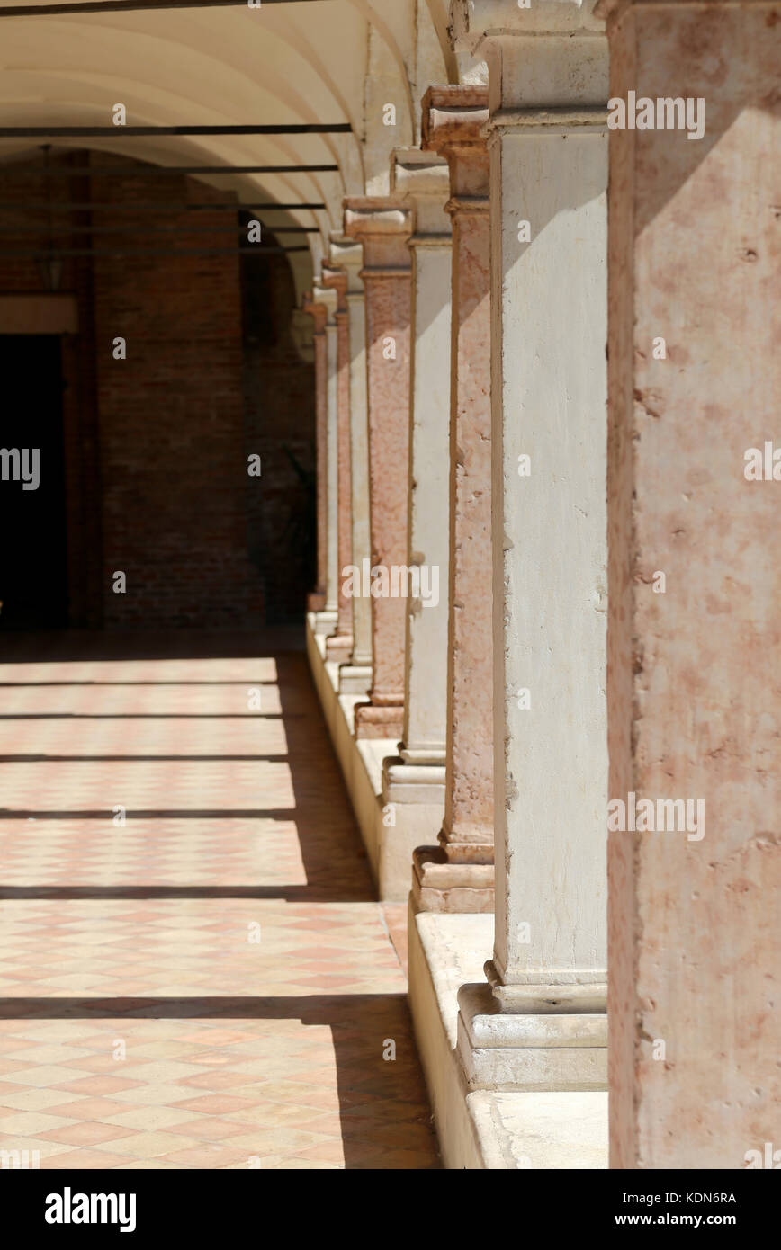 wide colonnade of a cloister in the ancient convent of friars in Italy ...