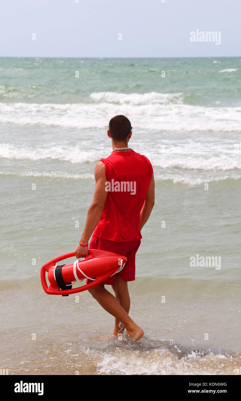 muscular guard lifeguard at shore at the sea shore in the beach of the ...
