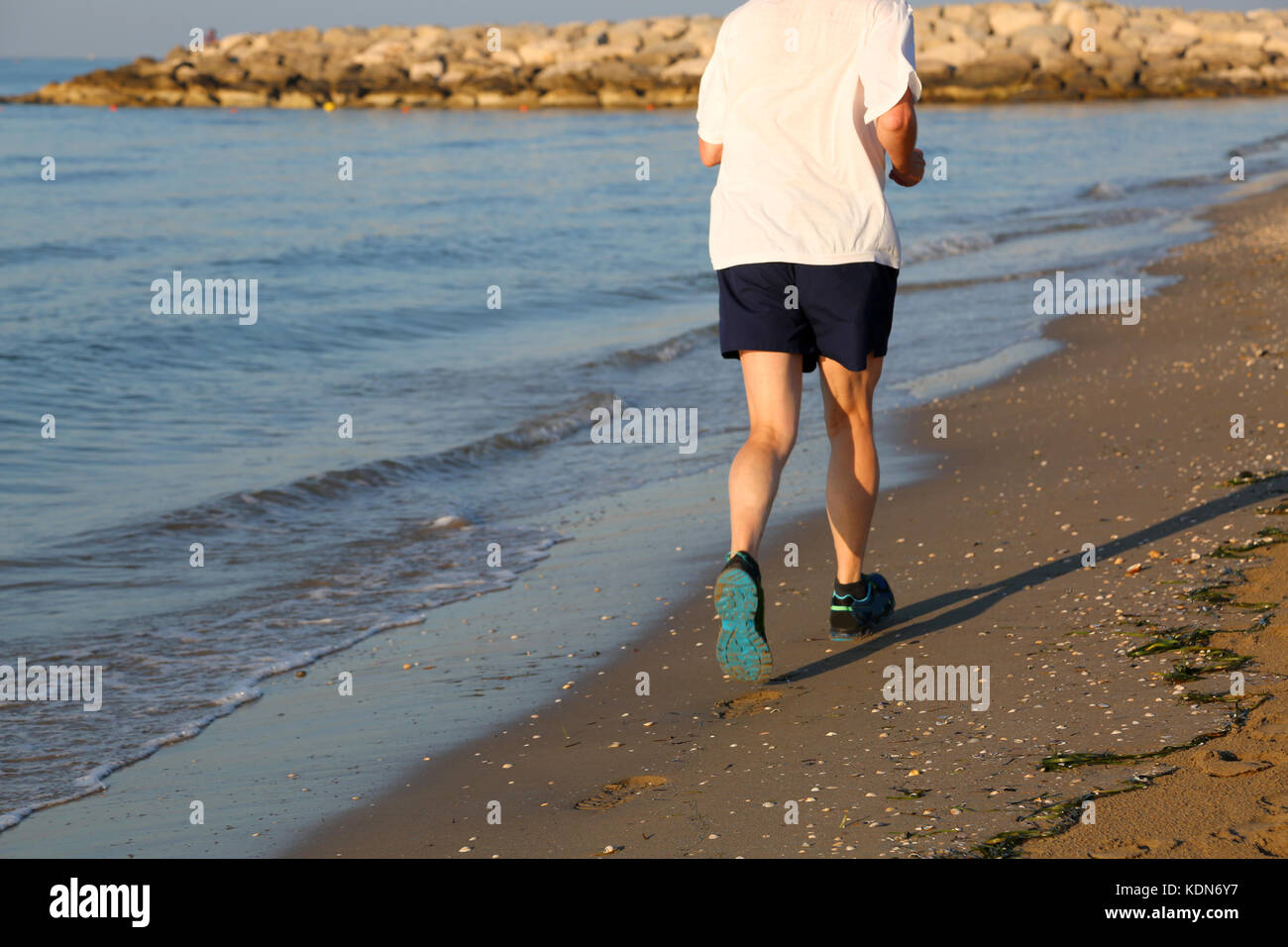 senior person jogging on the beach by the sea at dawn Stock Photo - Alamy