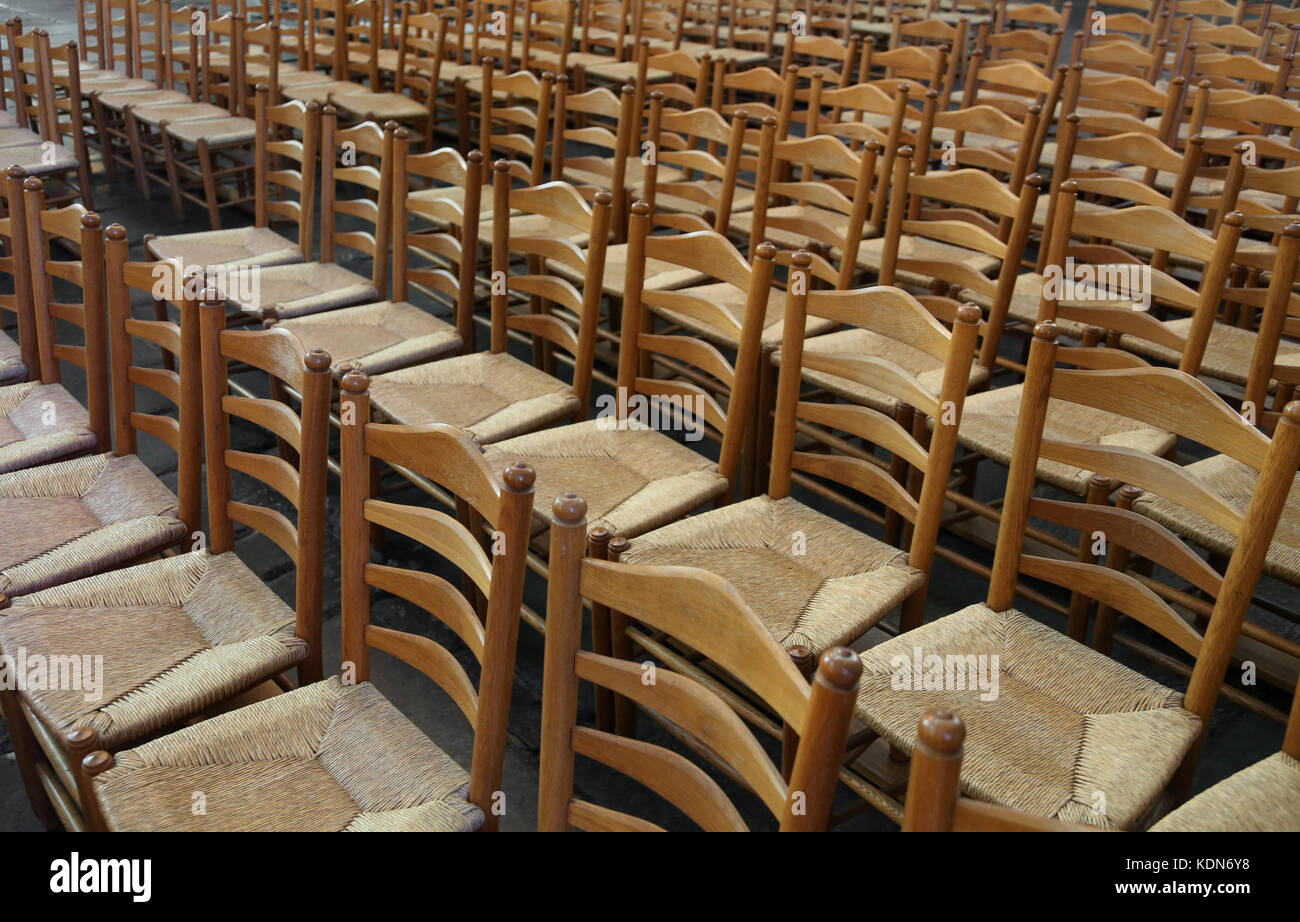 series of empty chairs with straw seat without people before Mass Stock ...