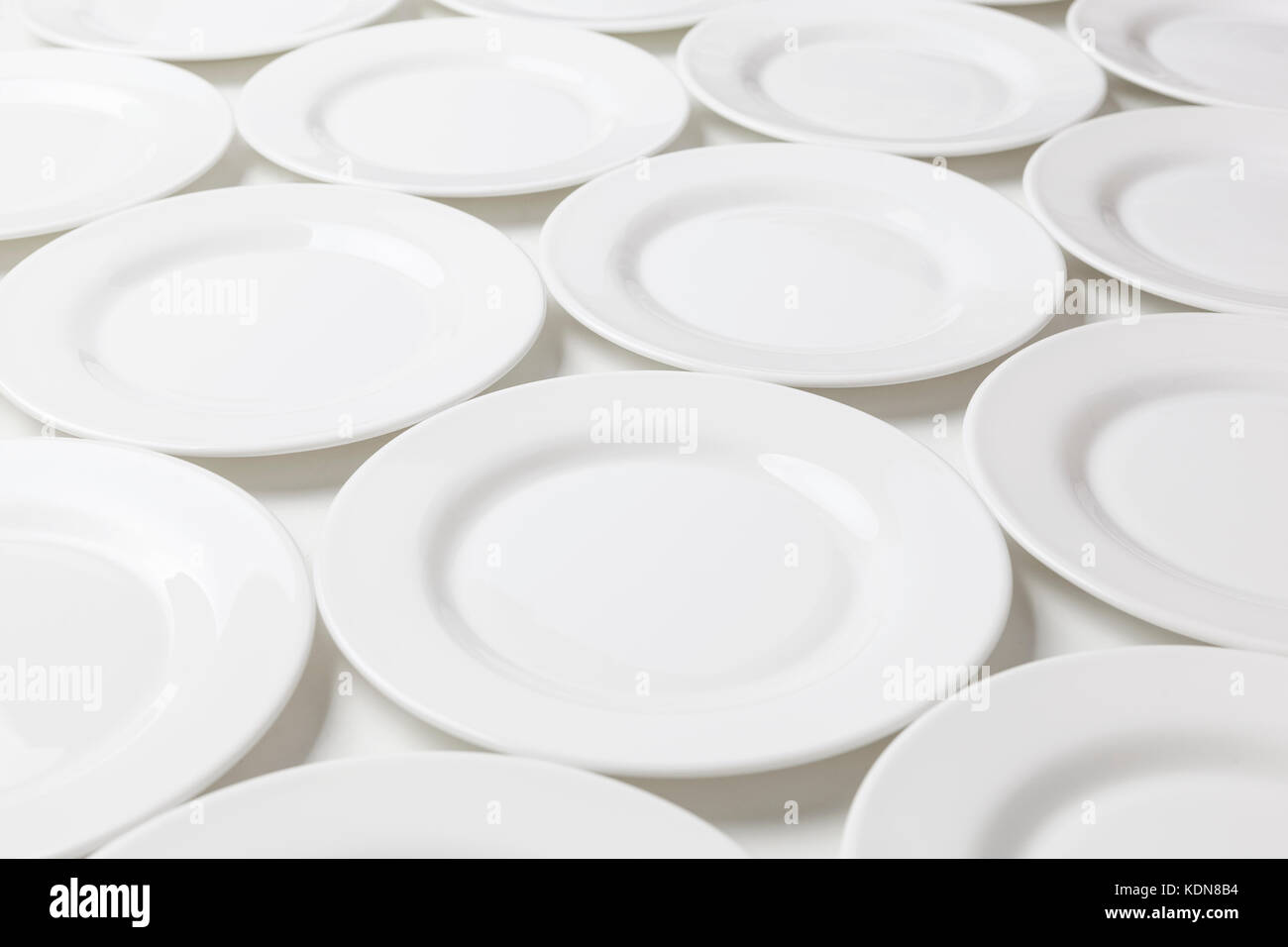 White round plates isolated on white background Stock Photo - Alamy