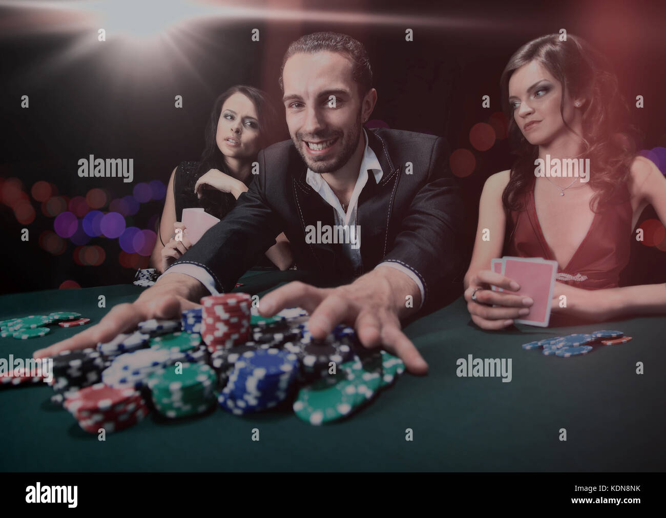 Poker player going "all in" pushing his chips forward Stock Photo - Alamy