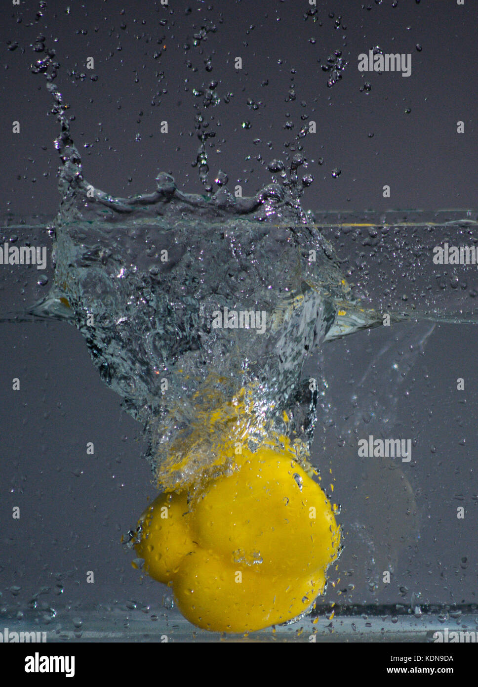Yellow bell pepper splashing in water Stock Photo - Alamy